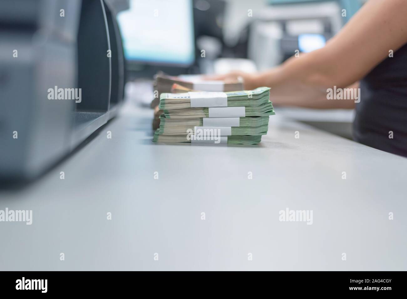 Bank employees sorting and counting money inside bank vault. Large ...