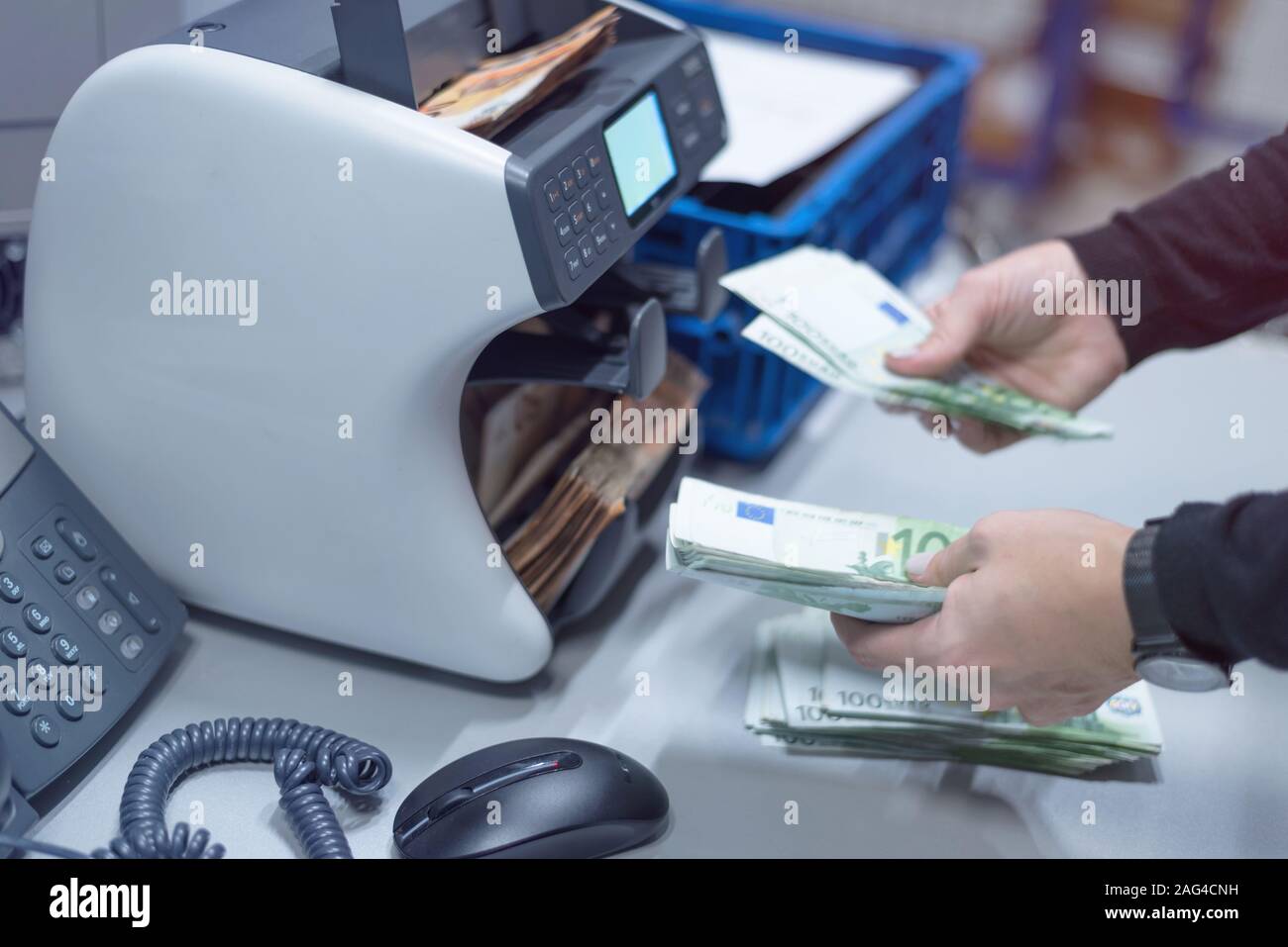 Bank employees sorting and counting money inside bank vault. Large ...