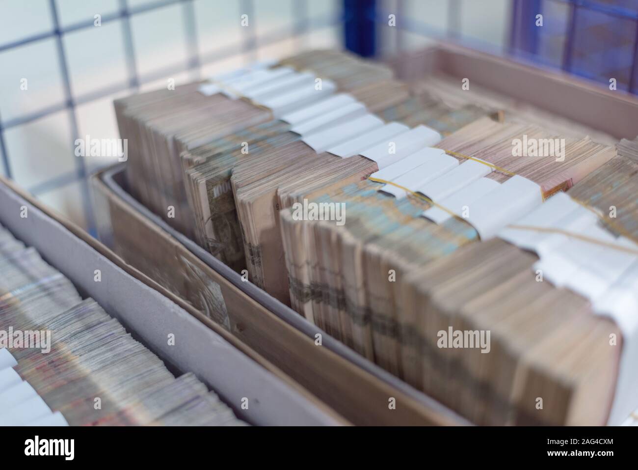 Bank employees sorting and counting money inside bank vault. Large ...