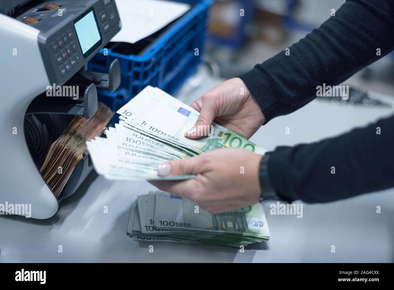 Bank employees sorting and counting money inside bank vault. Large ...