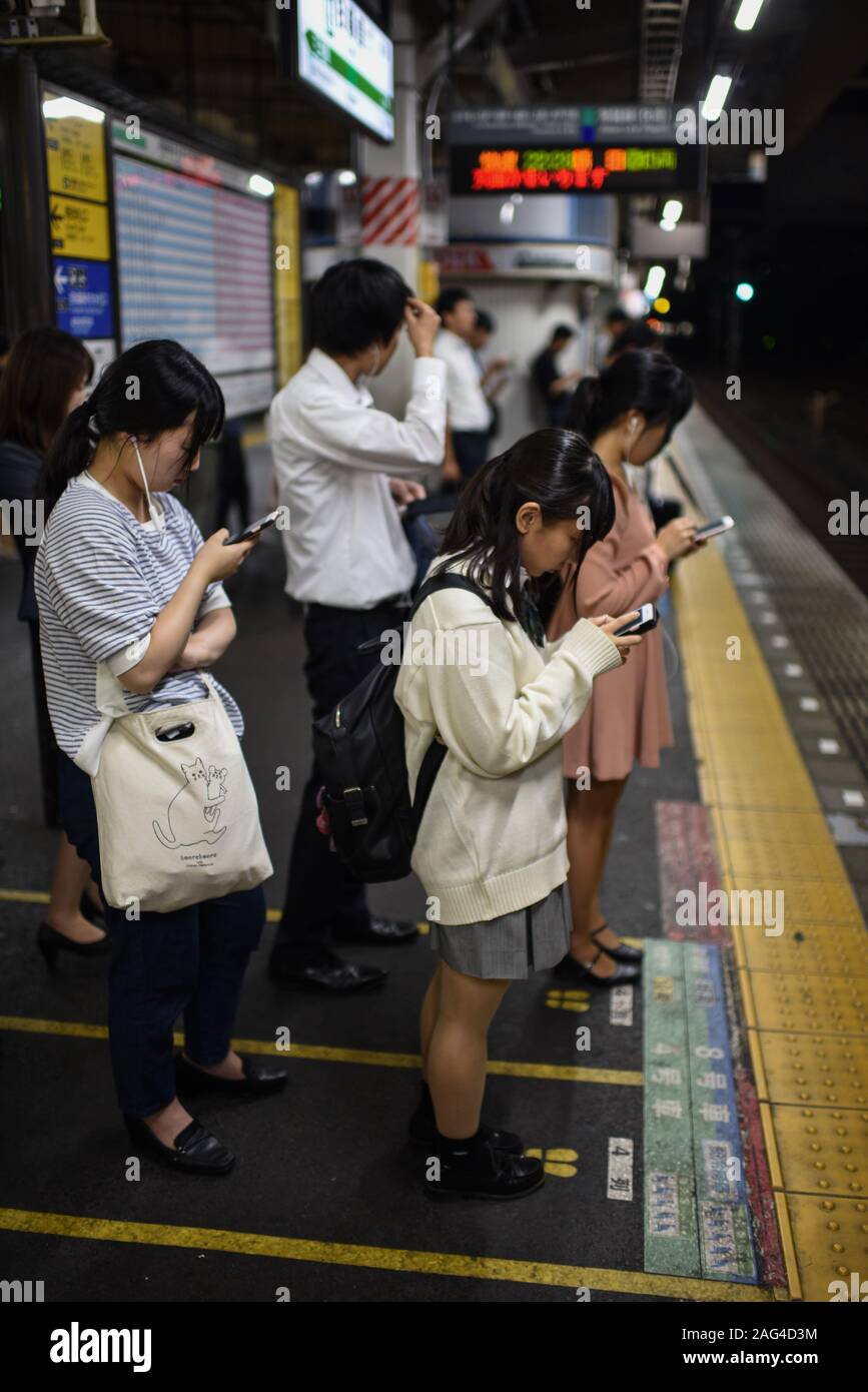 Group of people using phones subway hi-res stock photography and images ...