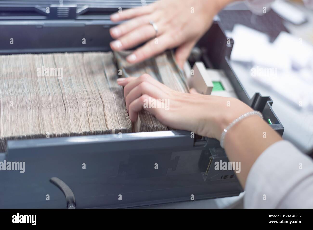 Bank employees sorting and counting money inside bank vault. Large ...