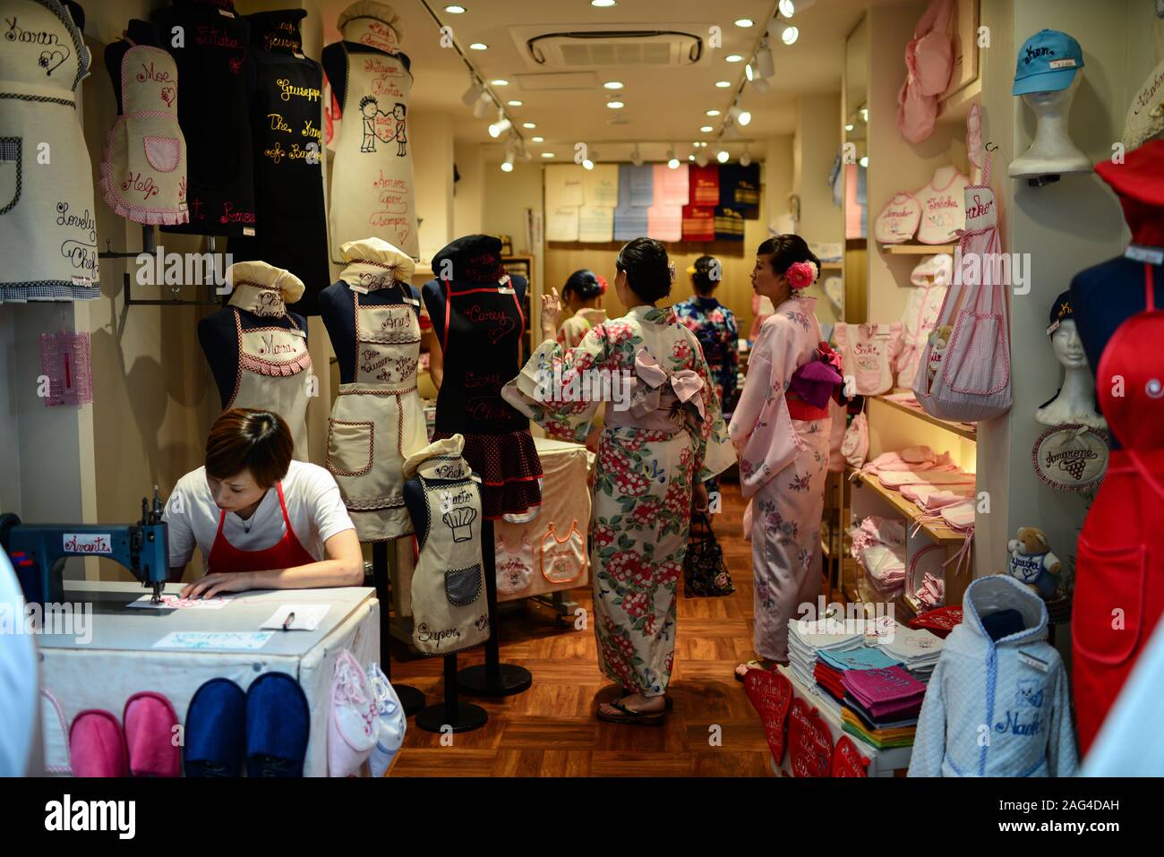 Women dressed in traditional Japanese clothes in store, Tokyo Stock ...