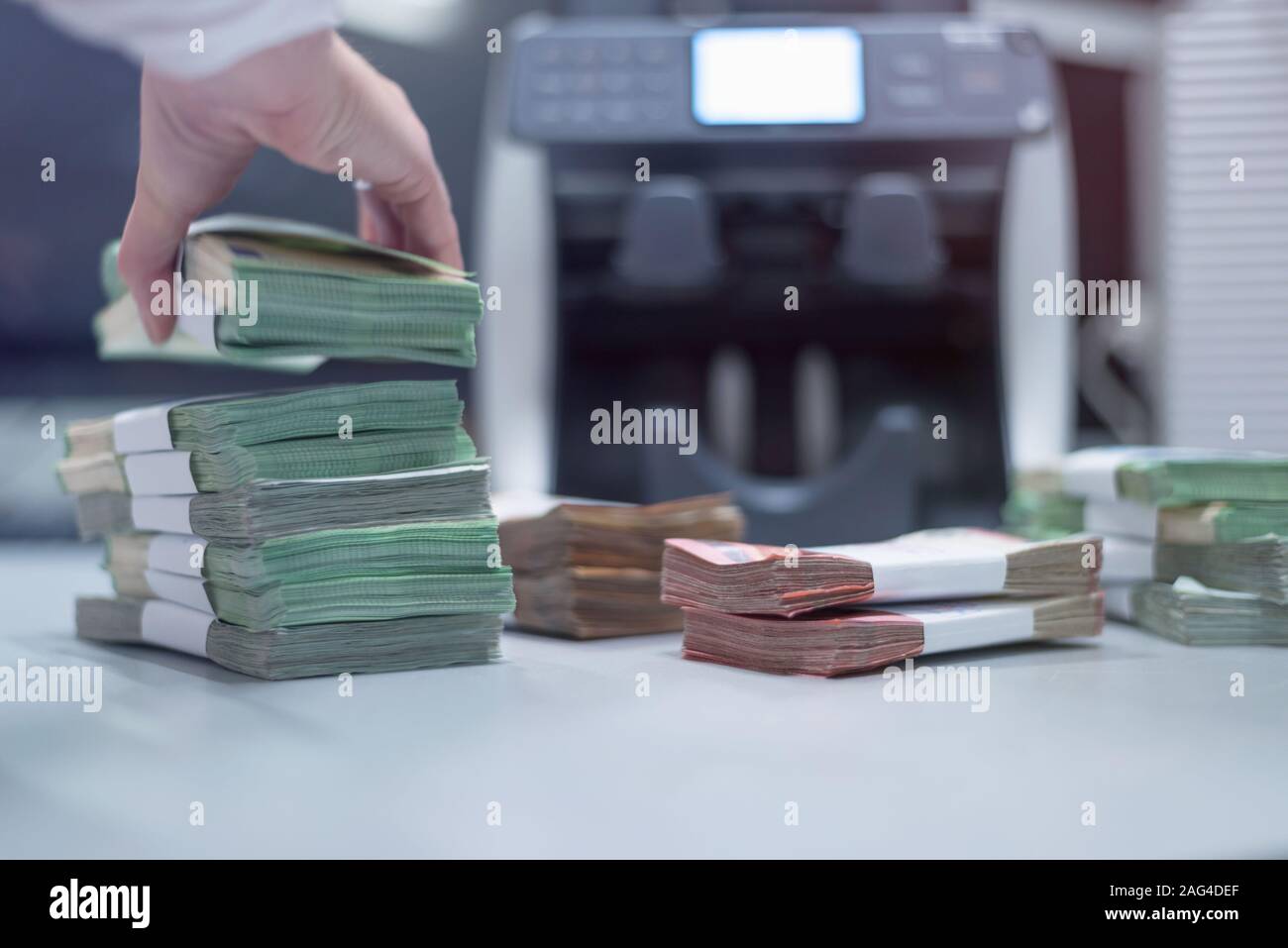 Bank employees sorting and counting money inside bank vault. Large ...