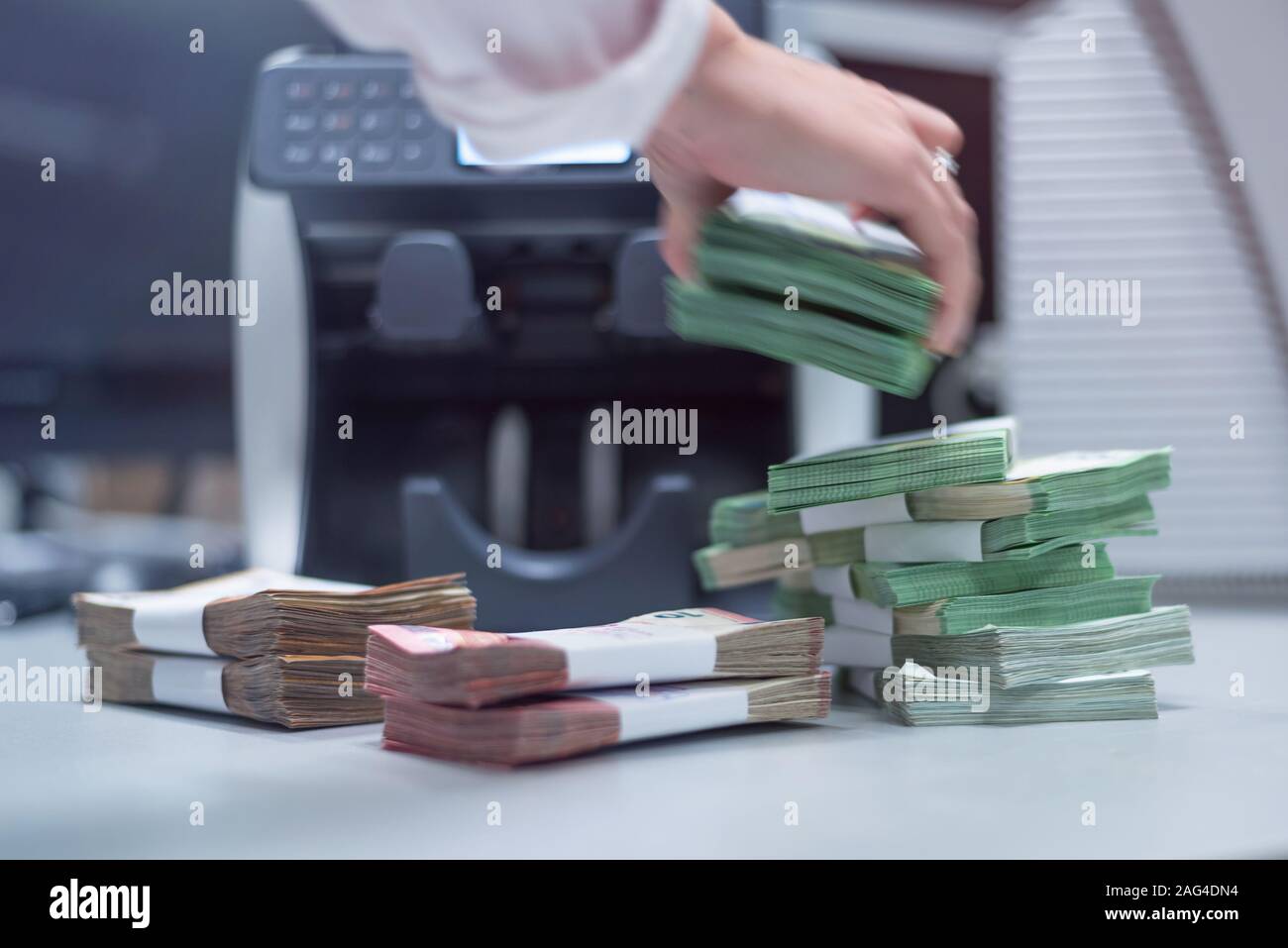 Bank employees sorting and counting money inside bank vault. Large ...