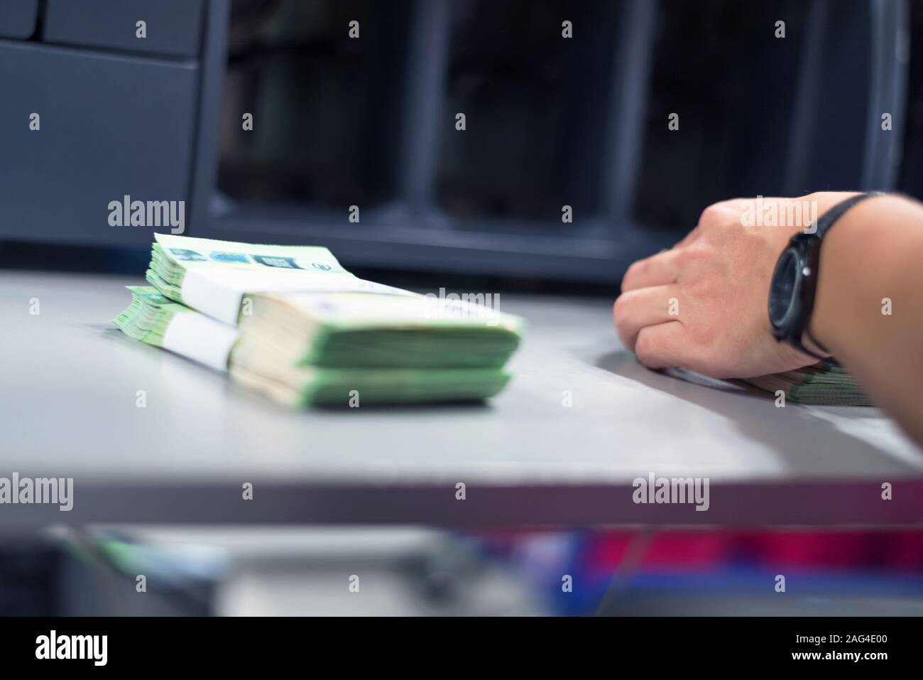 Bank employees sorting and counting money inside bank vault. Large ...