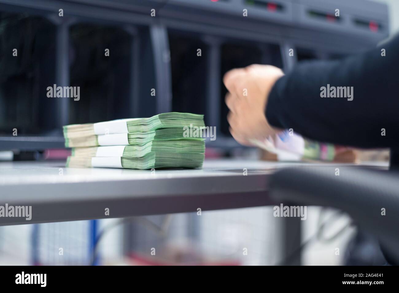 Bank employees sorting and counting money inside bank vault. Large ...