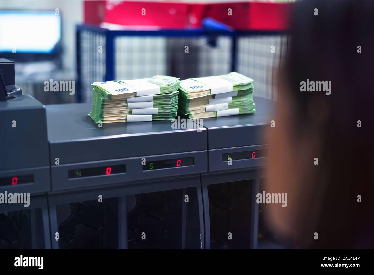 Bank employees sorting and counting money inside bank vault. Large ...