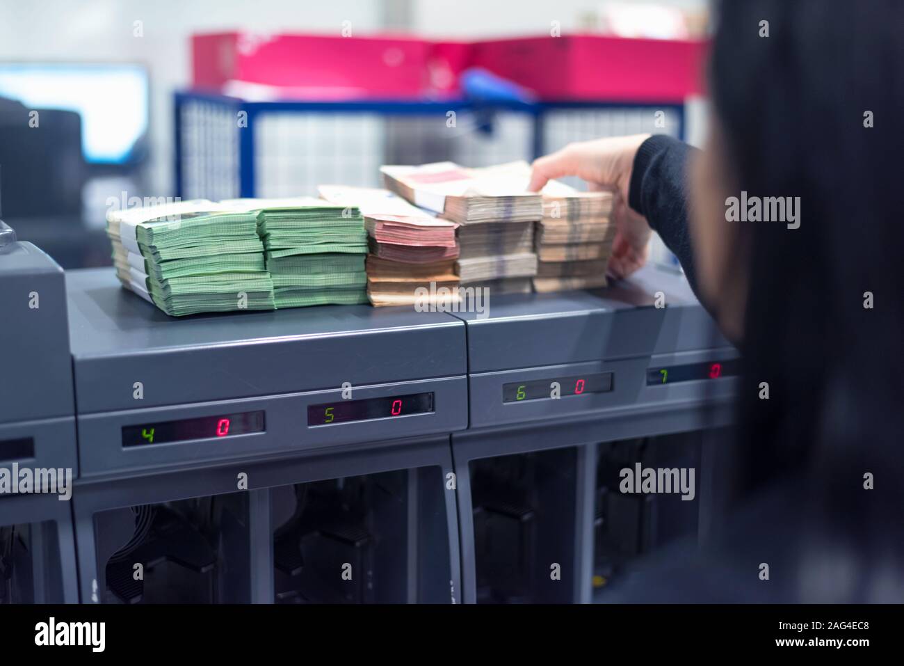 Bank employees sorting and counting money inside bank vault. Large ...