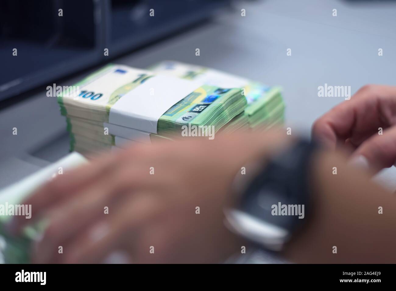 Bank employees sorting and counting money inside bank vault. Large ...