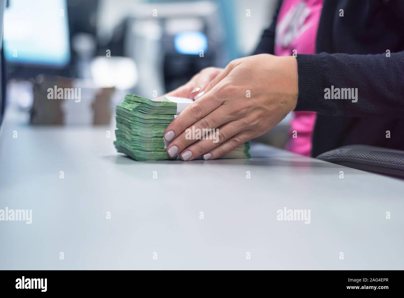 Bank employees sorting and counting money inside bank vault. Large ...