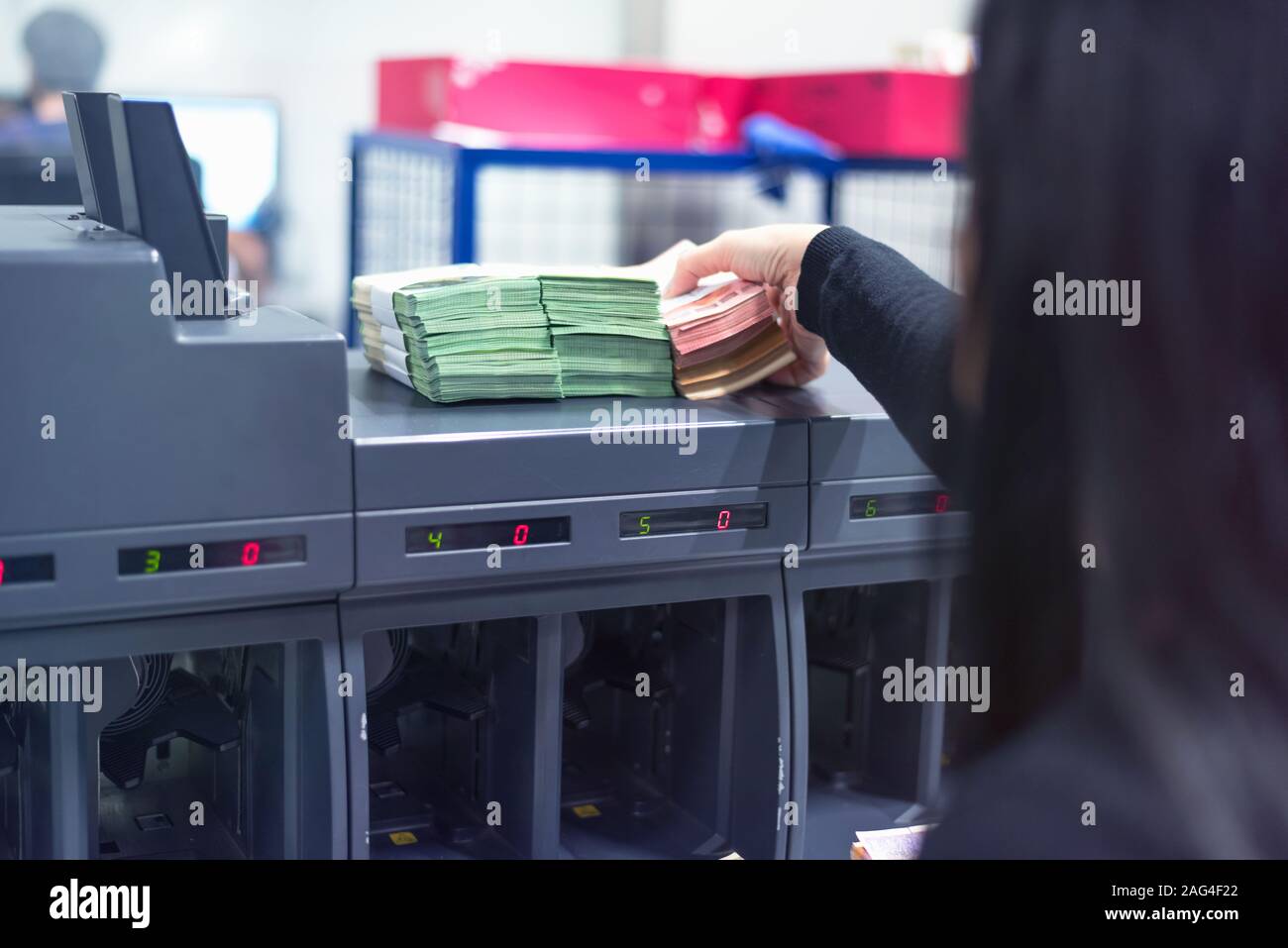 Bank employees sorting and counting money inside bank vault. Large ...