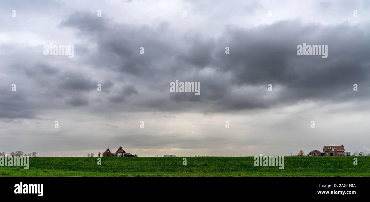 Polder landscape with houses behind the Merwede river dikes Stock Photo ...