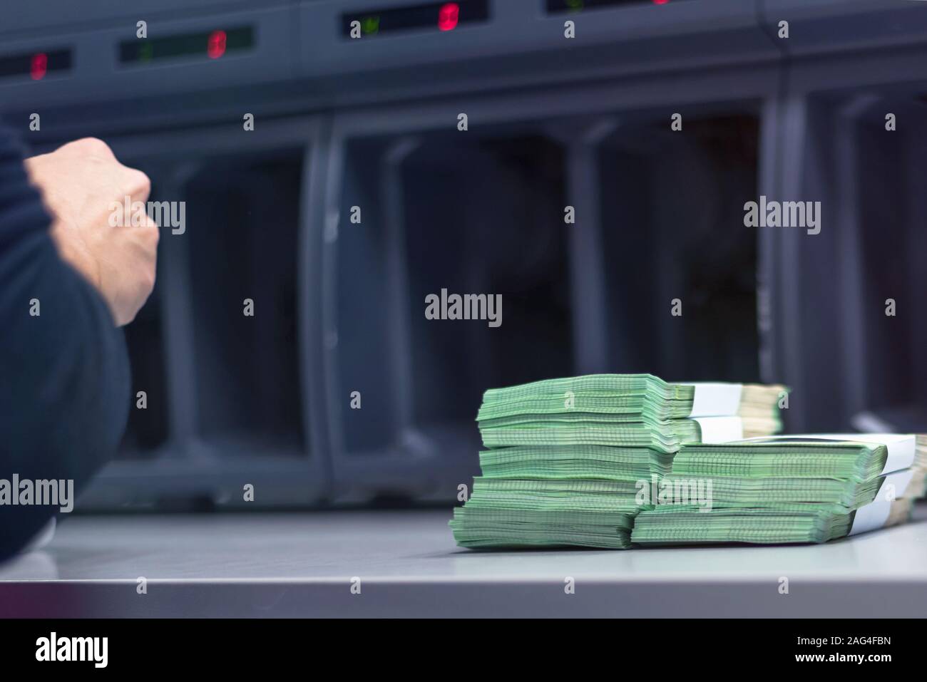 Bank employees sorting and counting money inside bank vault. Large ...