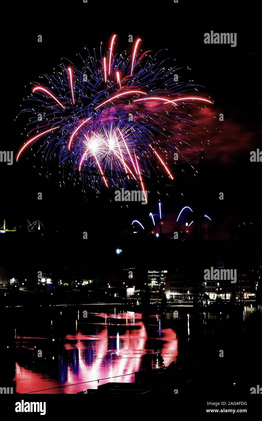 Vertical shot of fireworks spreading light and creating a festive ...