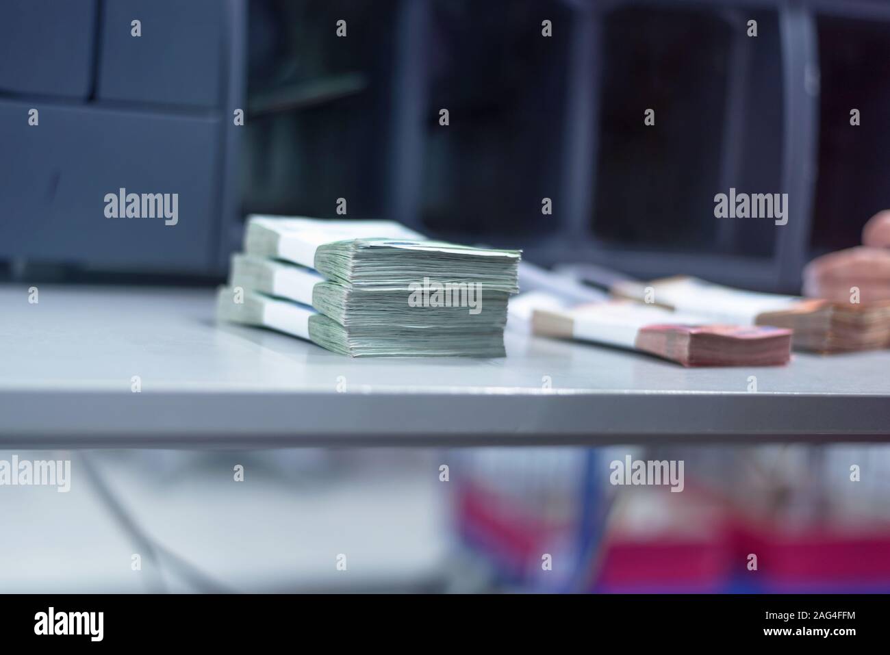 Bank employees sorting and counting money inside bank vault. Large ...