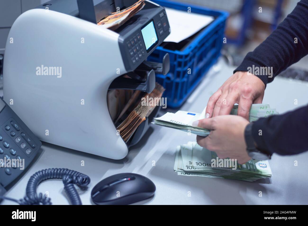 Bank employees sorting and counting money inside bank vault. Large ...