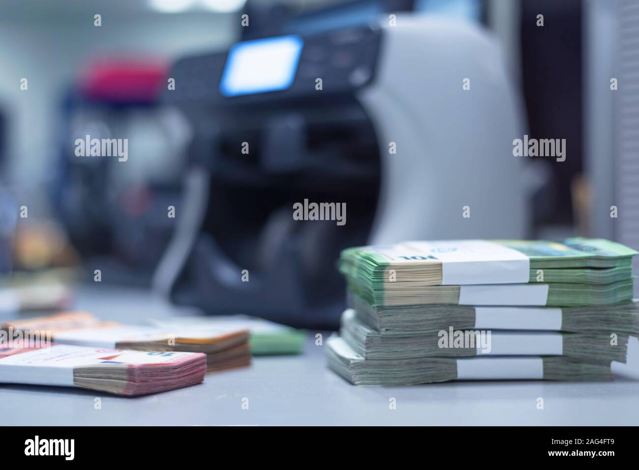Bank employees sorting and counting money inside bank vault. Large ...