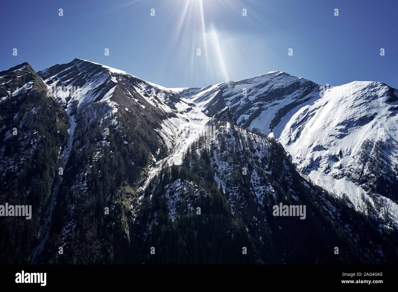 Beautiful low angle shot of a mountain with snow covering the peak and ...