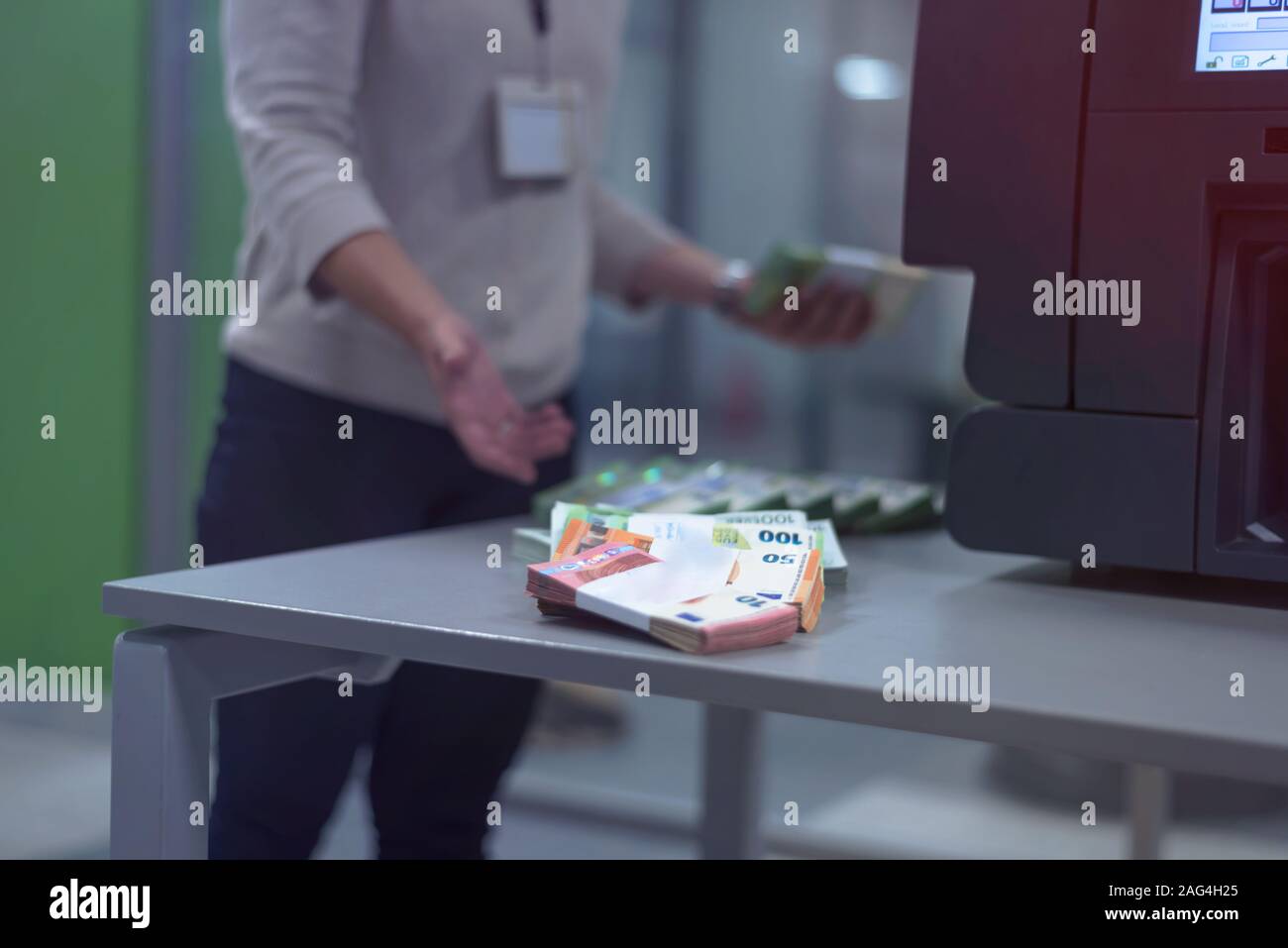 Finance person organizing large number of banknotes at the center for ...