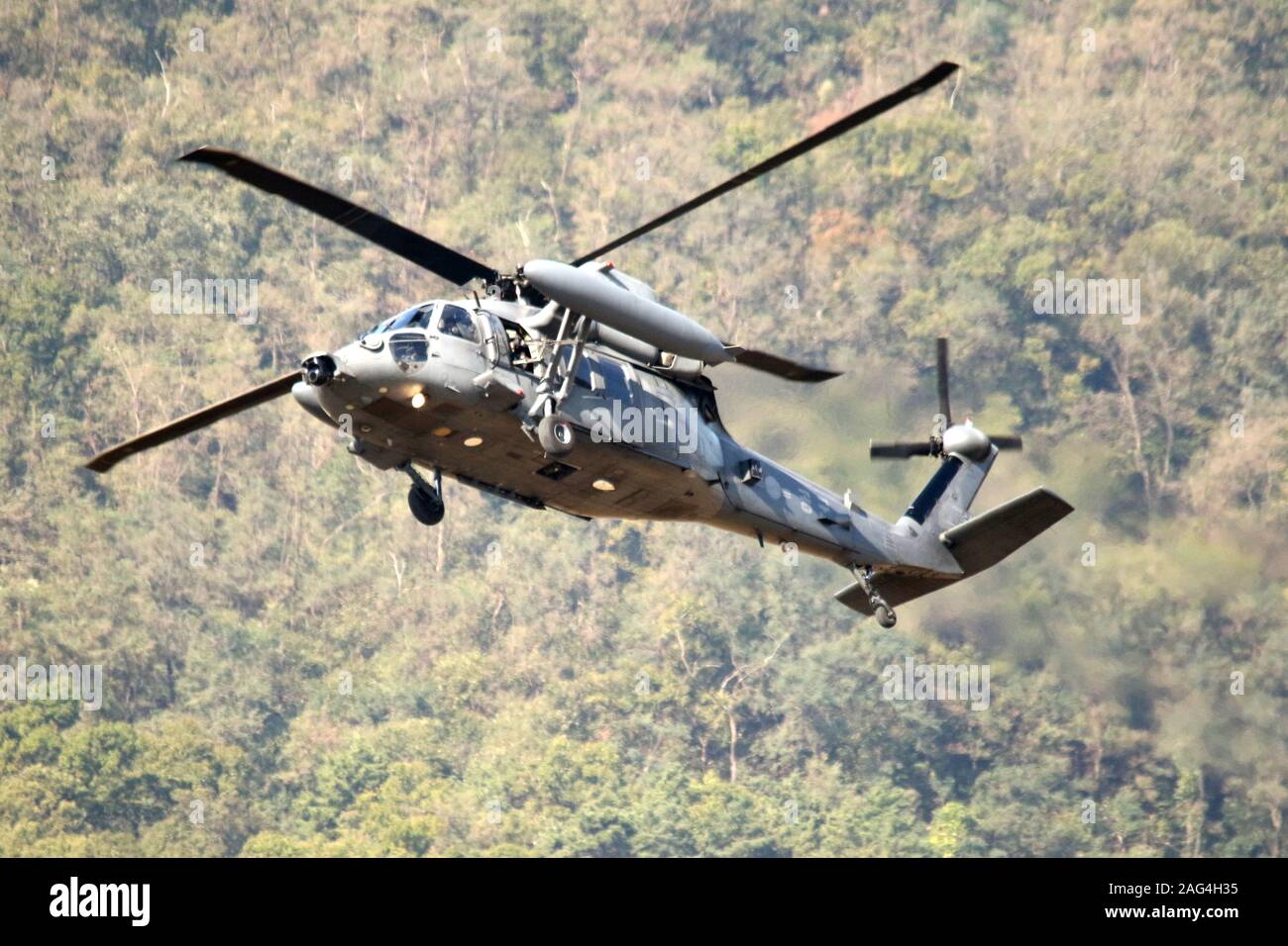Low angle closeup shot of a Sikorsky UH-60 Black Hawk flying above a ...