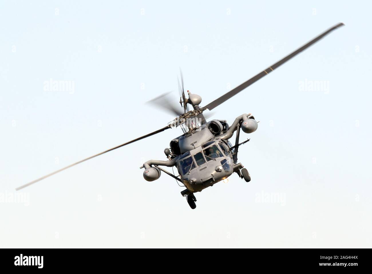 Low angle isolated shot of a military hawk maneuvring on a white ...