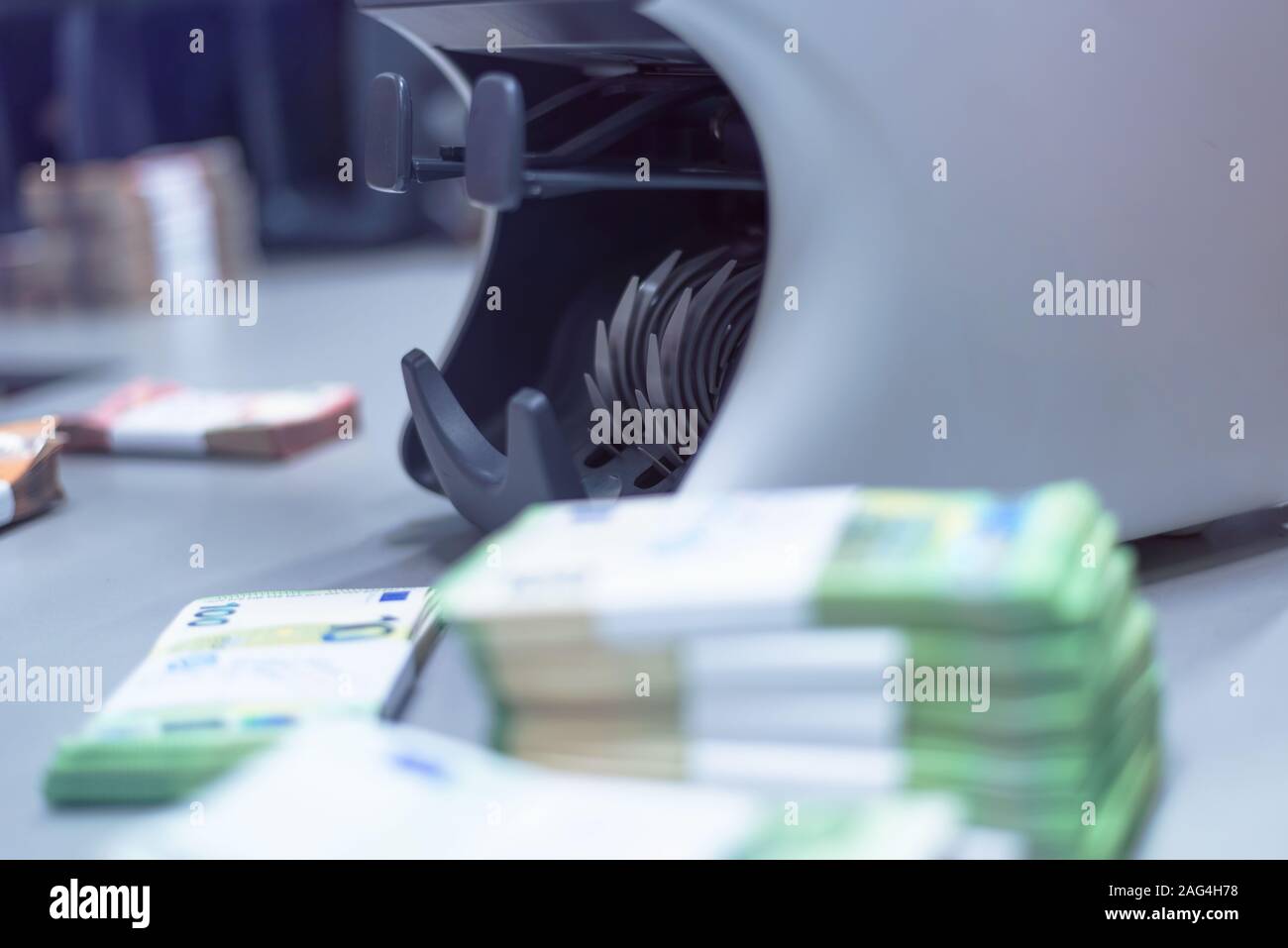 Bank employees sorting and counting money inside bank vault. Large ...