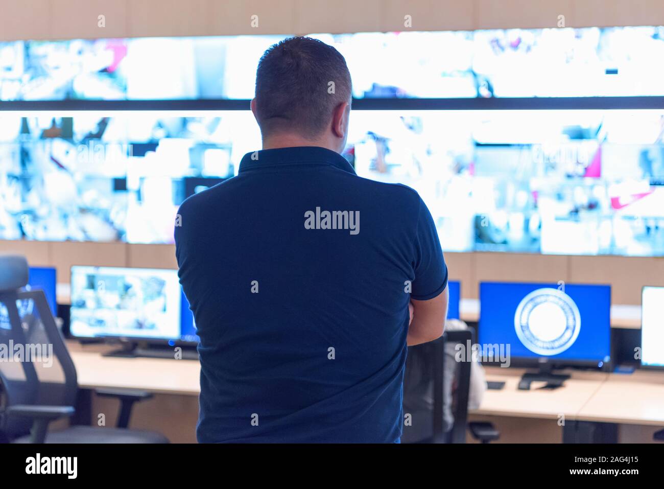 Security guard monitoring modern CCTV cameras in surveillance room ...