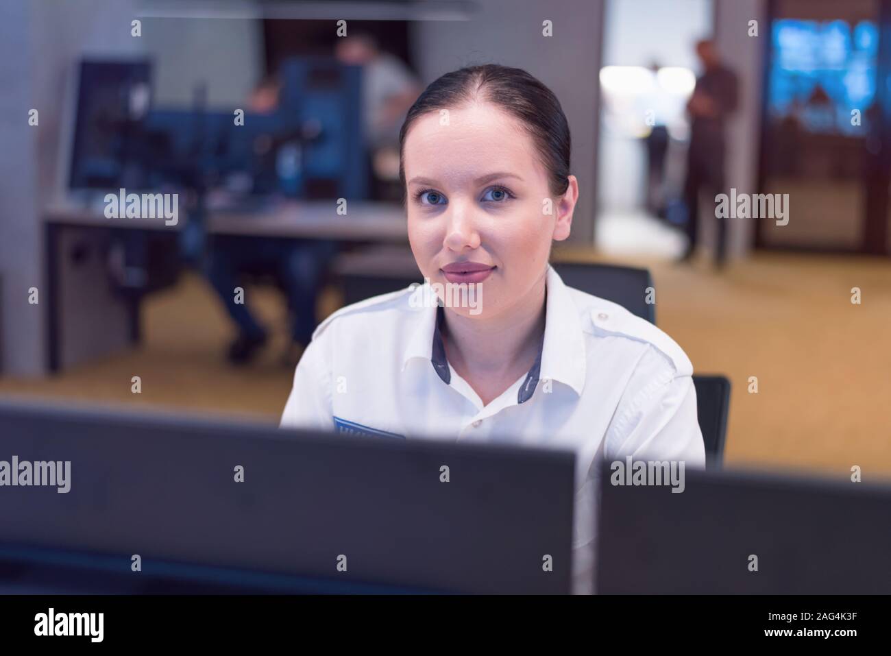 Security guard monitoring modern CCTV cameras in surveillance room ...
