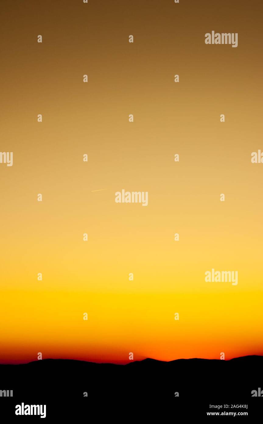 Vertical shot of the sun setting over the silhouette of a city Stock ...
