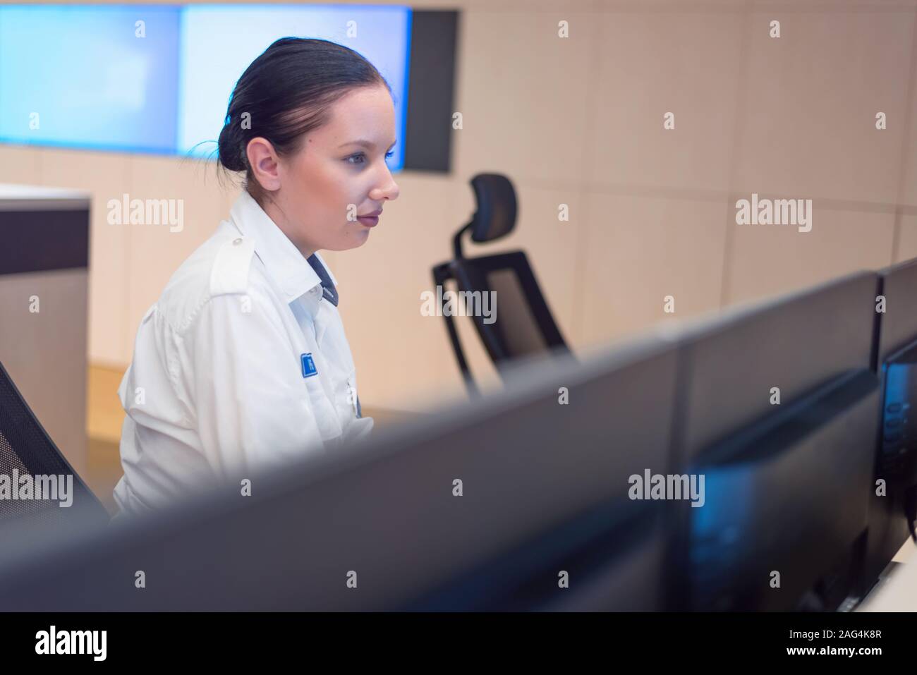 Security guard monitoring modern CCTV cameras in surveillance room ...