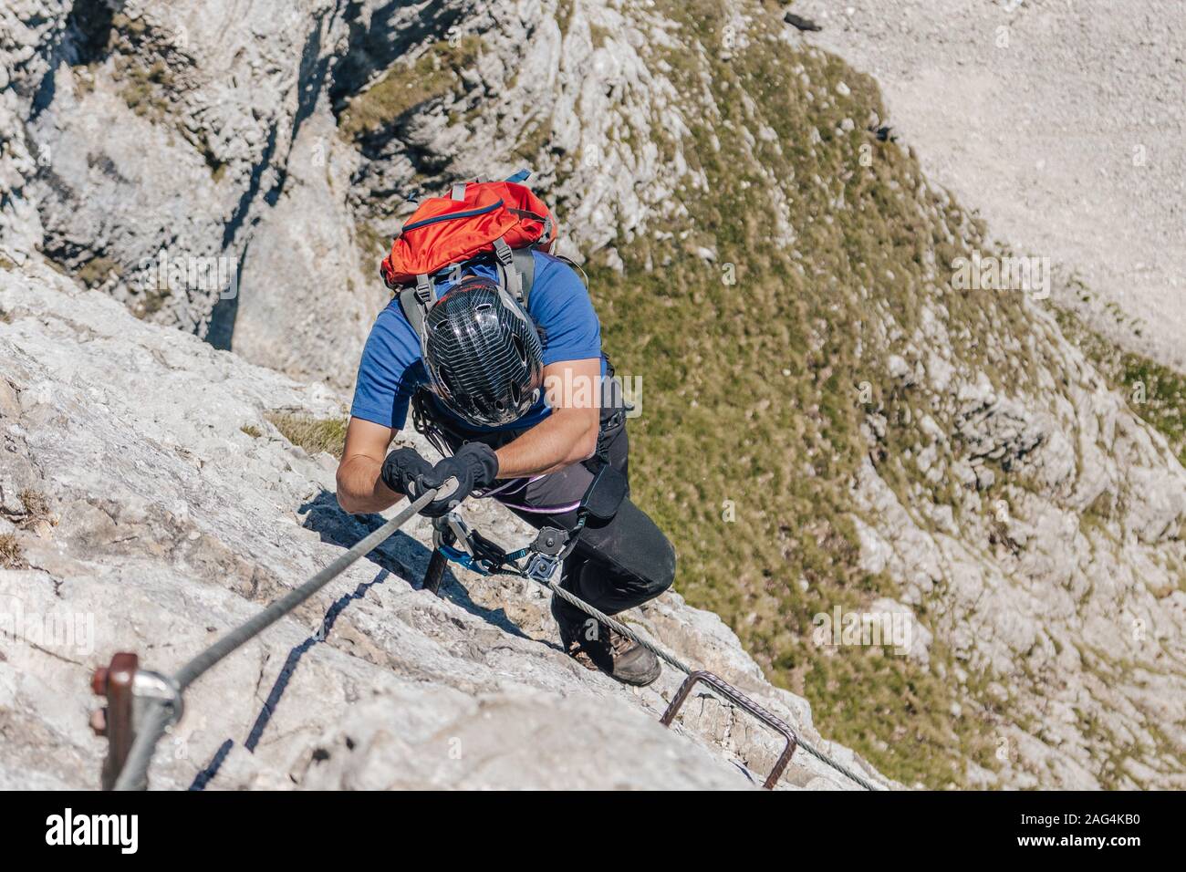Climber climbing via ferrata. Adventure extreme ascent of an alpine ...