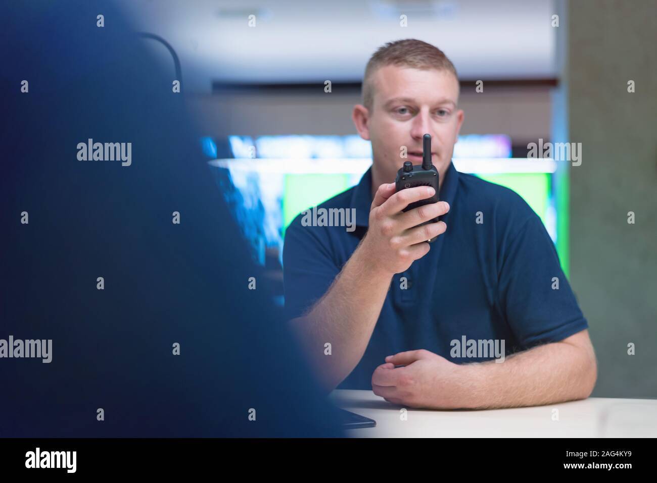 Security guard monitoring modern CCTV cameras in surveillance room ...