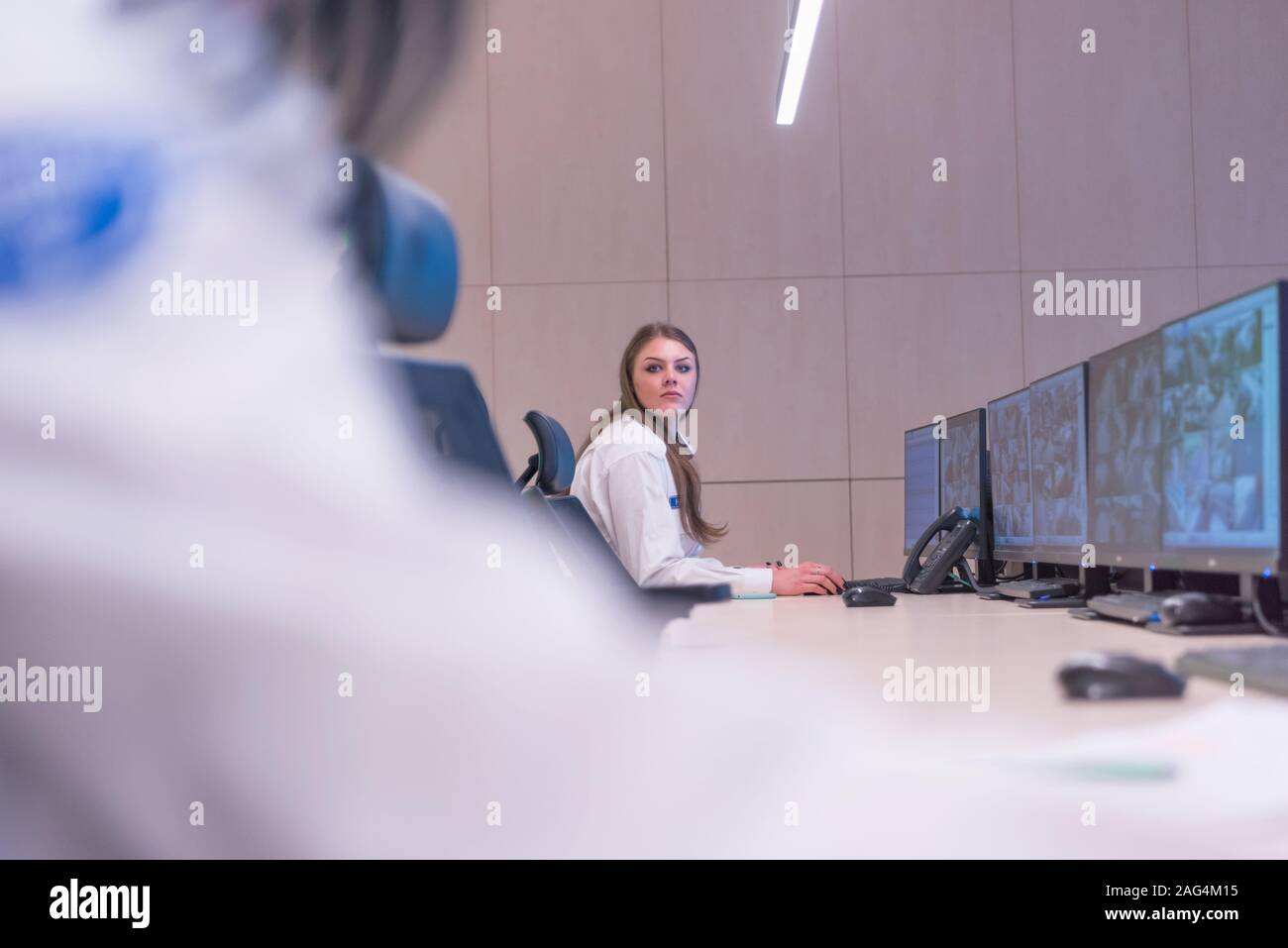Security guard monitoring modern CCTV cameras in surveillance room ...
