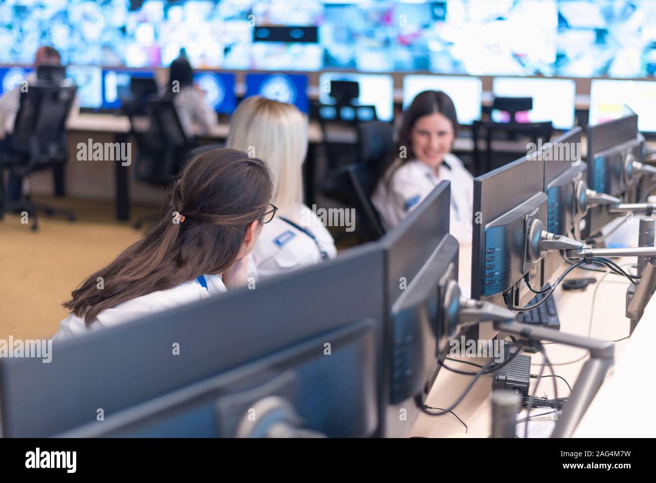 Security guard monitoring modern CCTV cameras in surveillance room ...