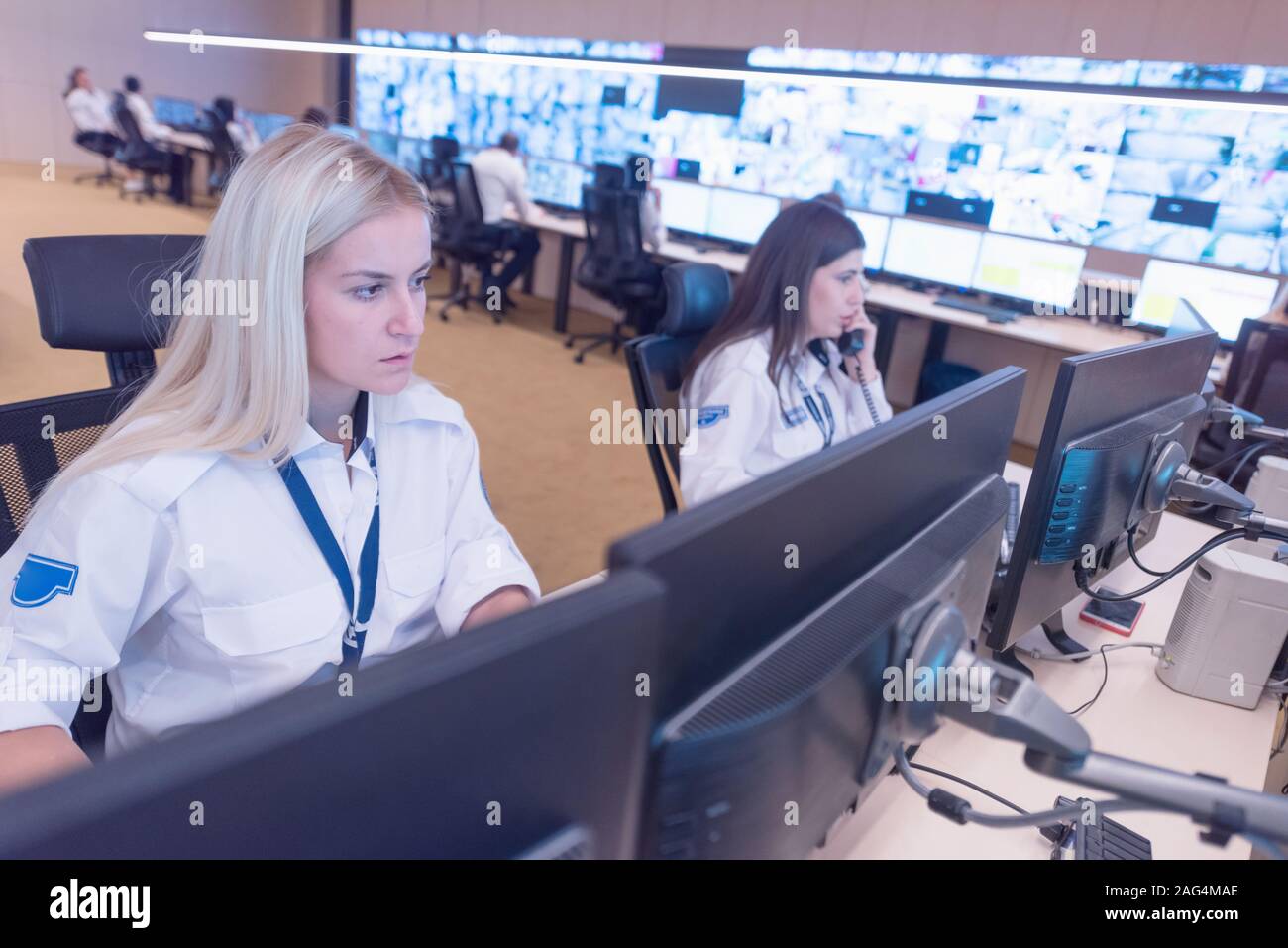 Security guard monitoring modern CCTV cameras in surveillance room ...