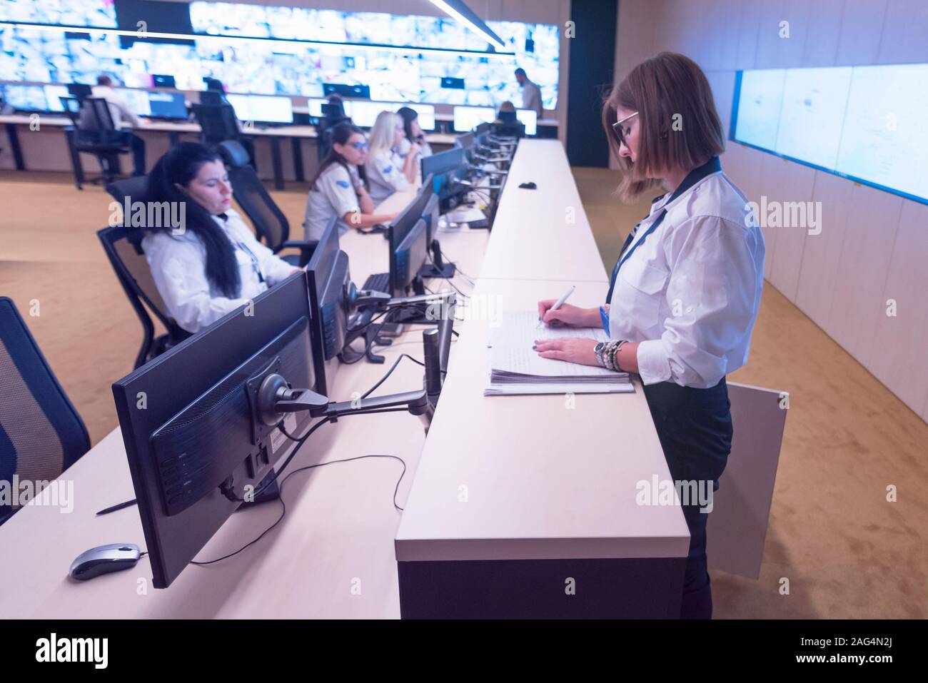 Security guard monitoring modern CCTV cameras in surveillance room ...