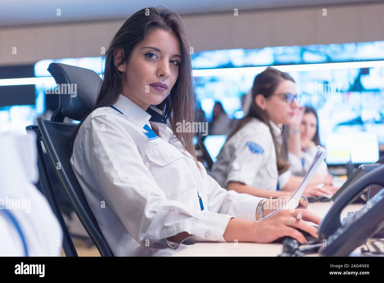 Security guard monitoring modern CCTV cameras in surveillance room ...