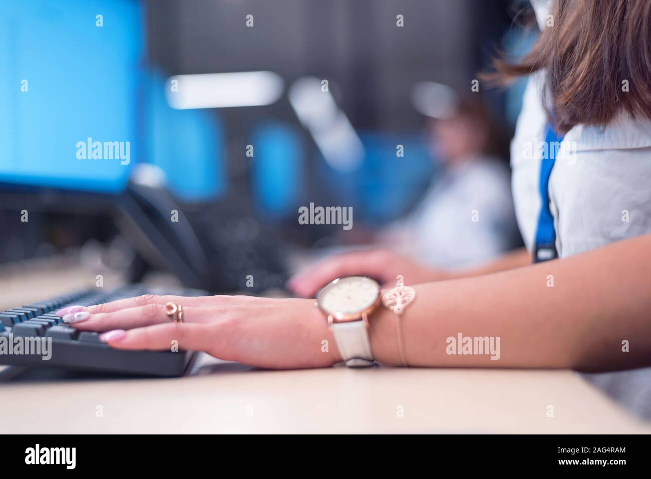 Group of security guards working on computers while sitting in the main ...