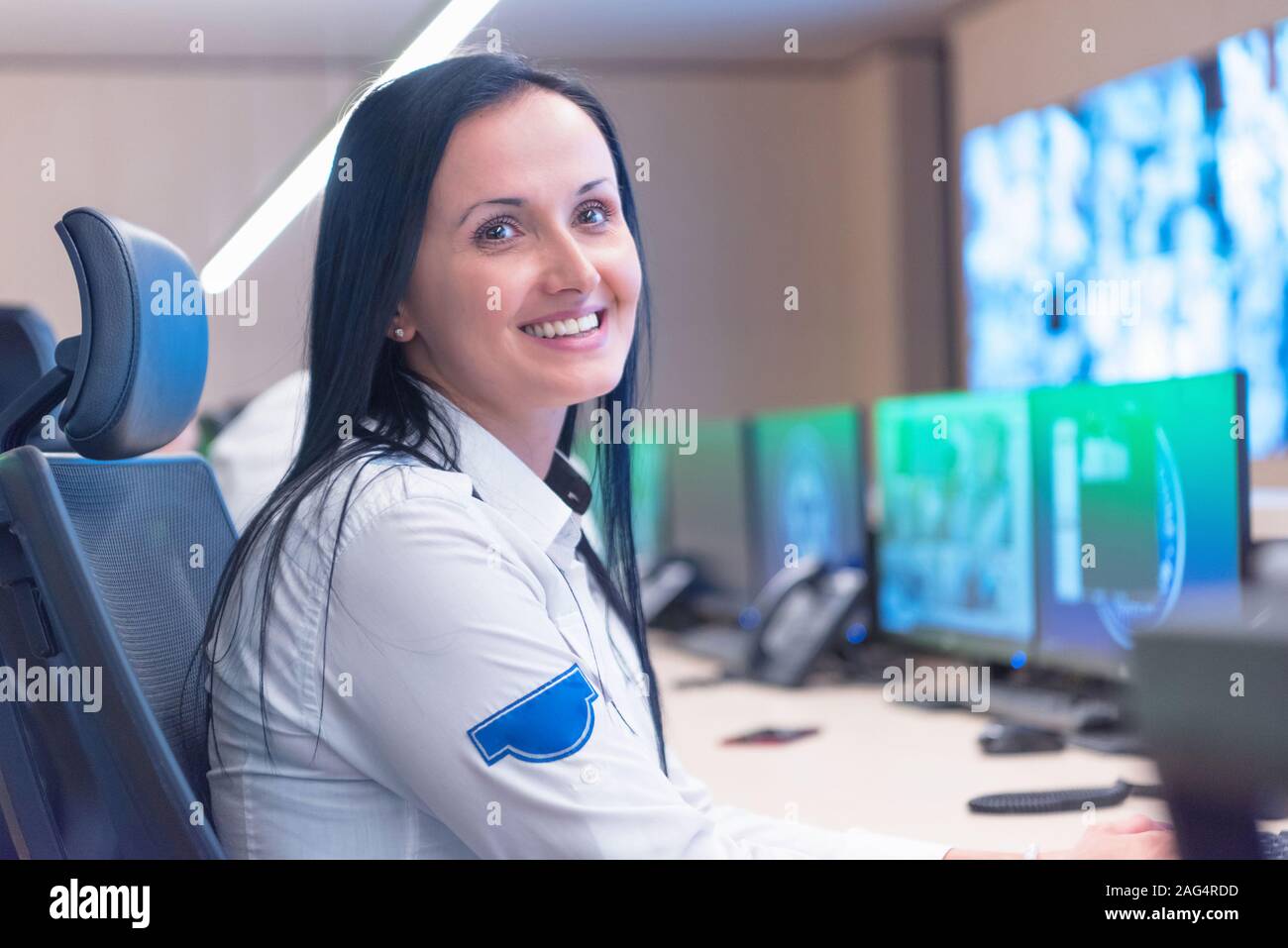 Security guard monitoring modern CCTV cameras in surveillance room ...