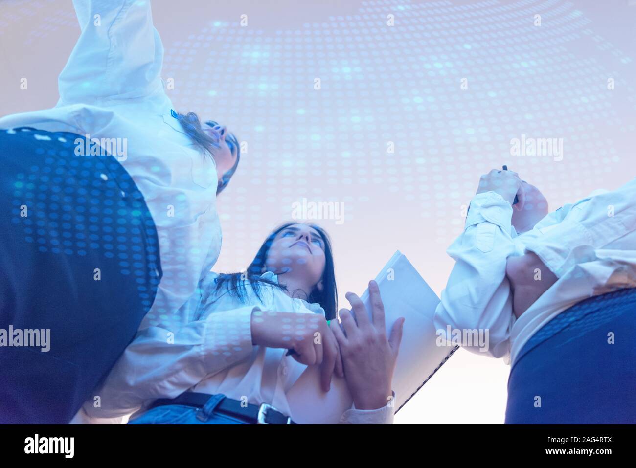 Group of security guards working on computers while sitting in the main ...