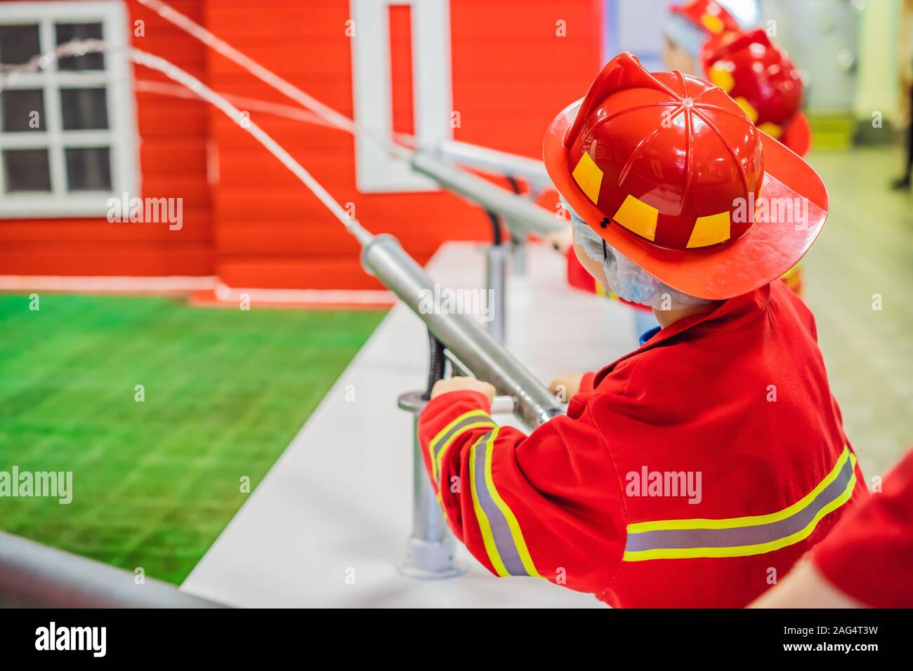 Expressive cute toddler with fireman's outfit playing fireman Stock ...