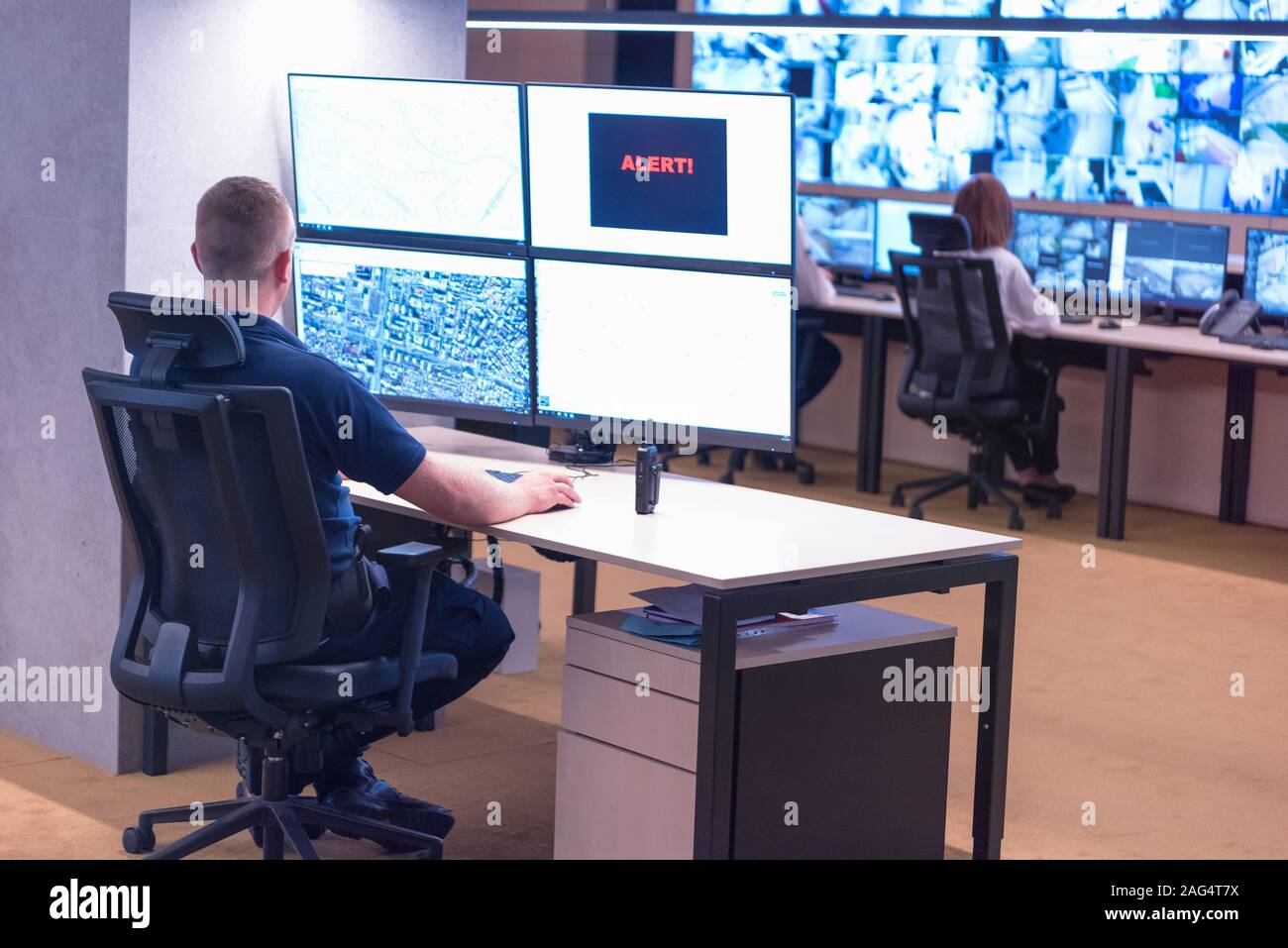 Security guard monitoring modern CCTV cameras in surveillance room ...