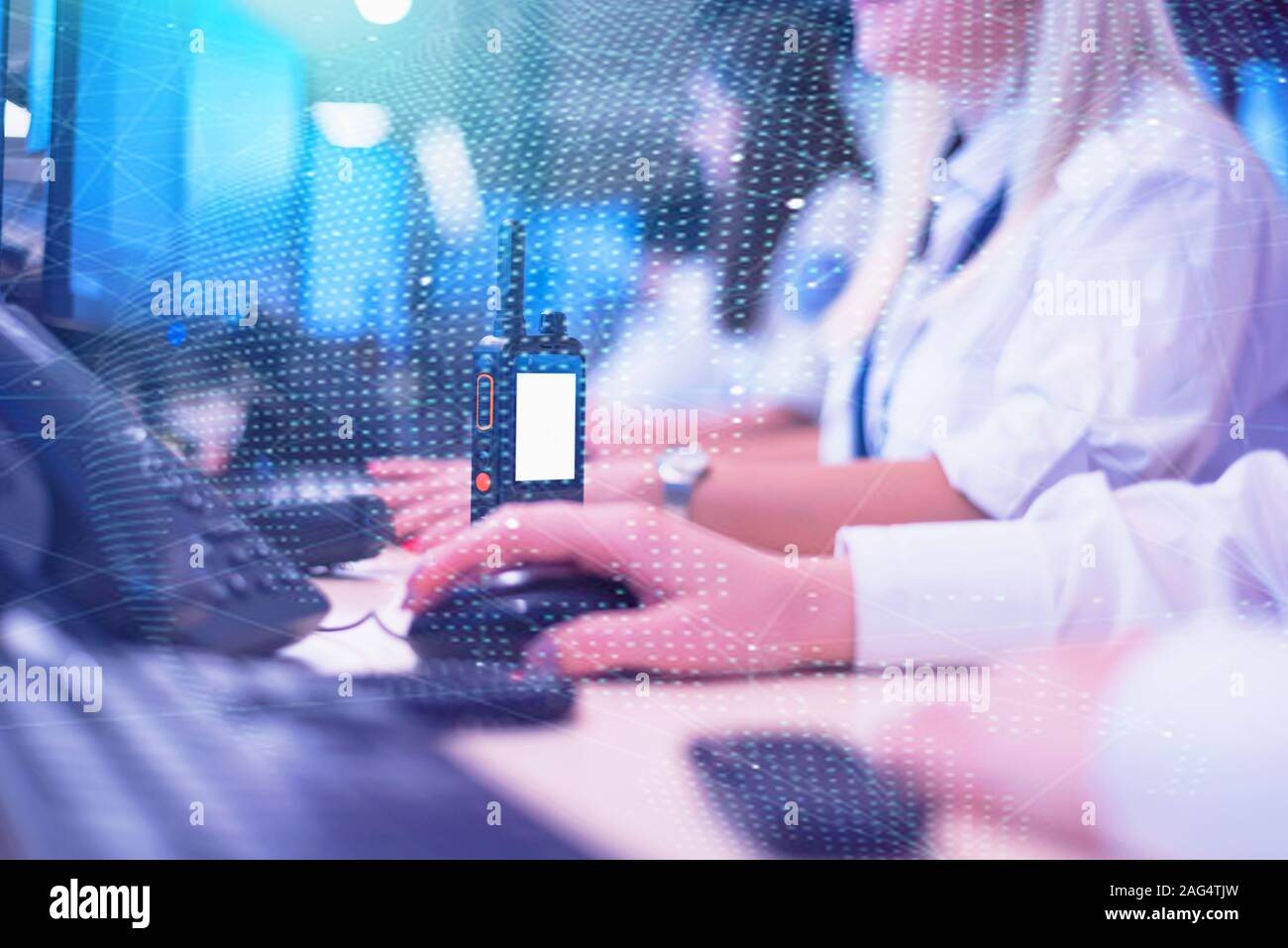 Group of security guards working on computers while sitting in the main ...