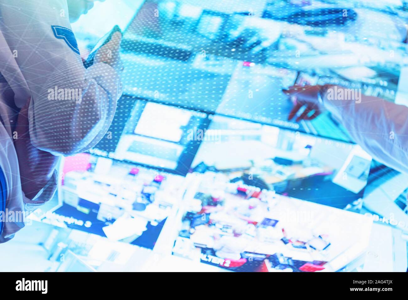 Group of security guards working on computers while sitting in the main ...