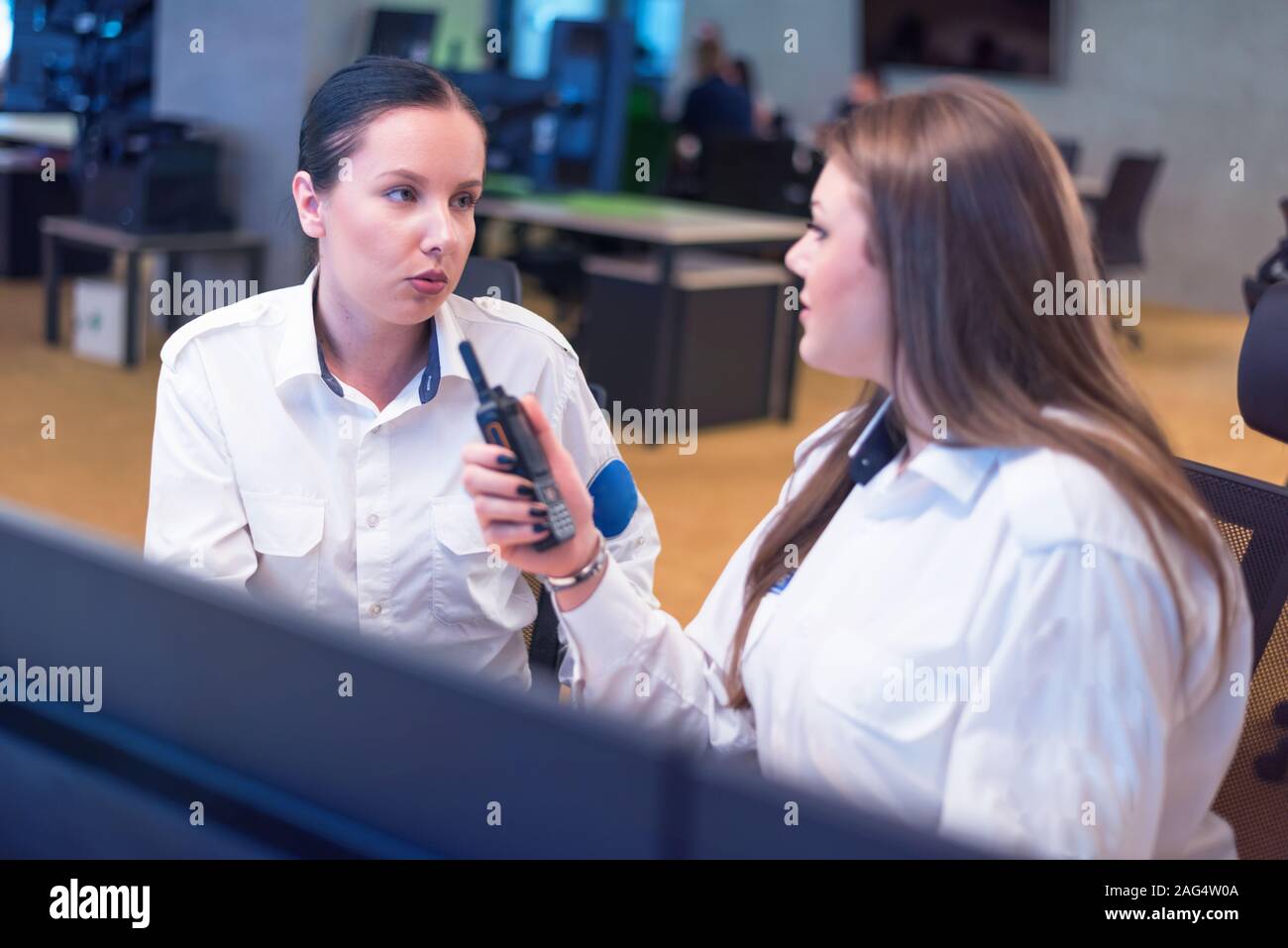 Security guard monitoring modern CCTV cameras in a surveillance room ...