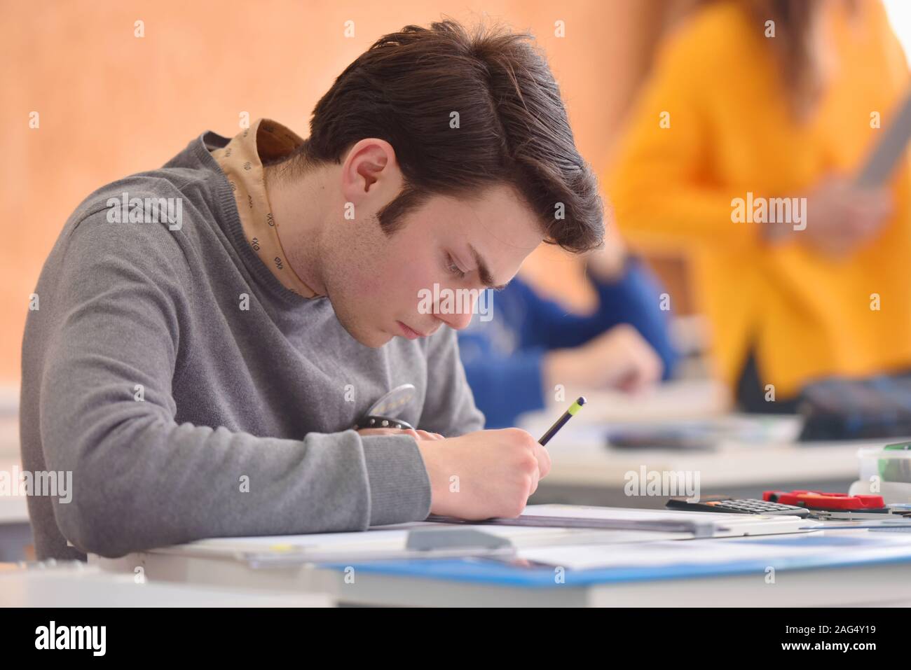 Male university architecture student working on practice lessons ...