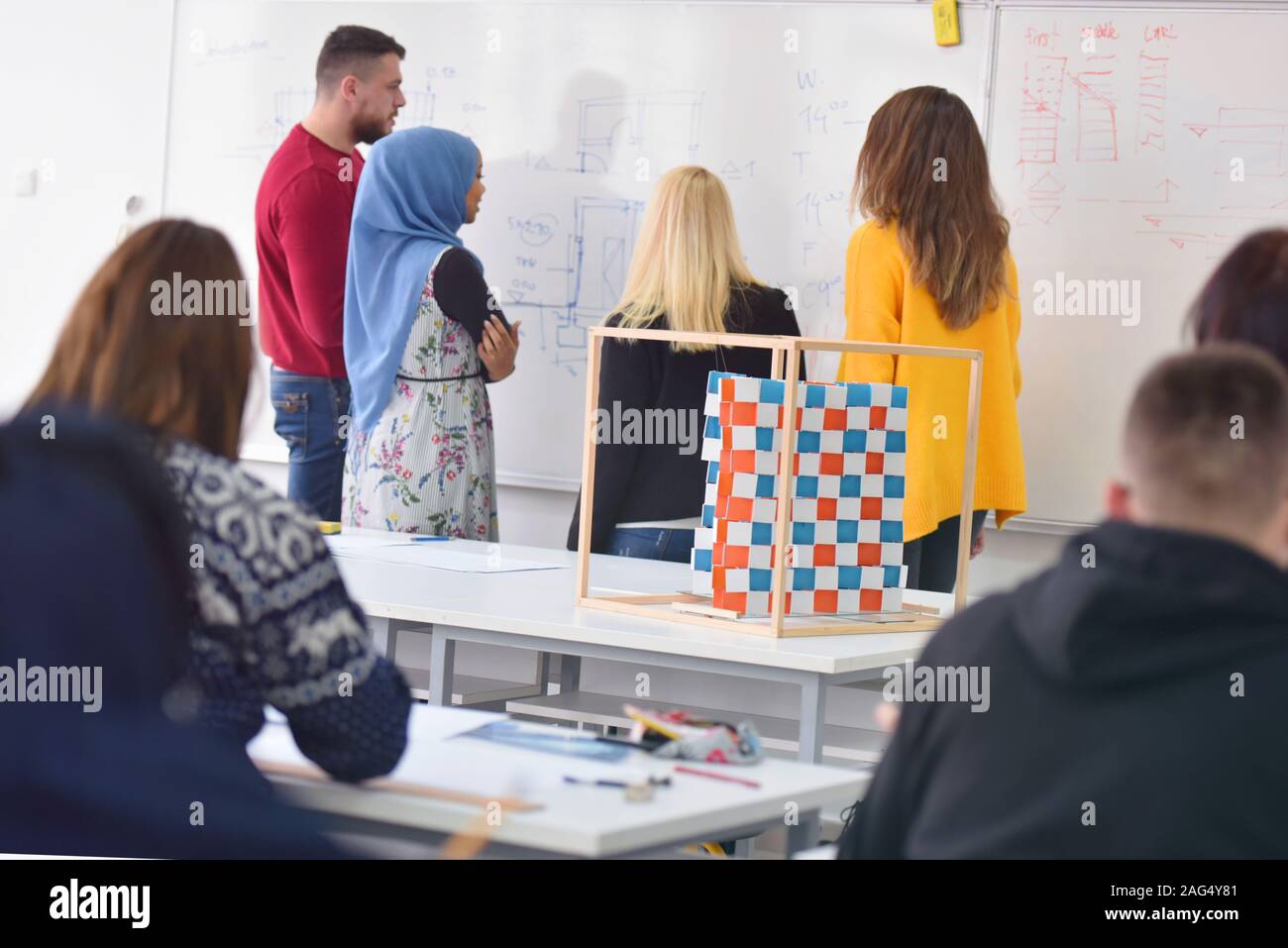 Beautiful female university professor of architecture explain lesson to ...