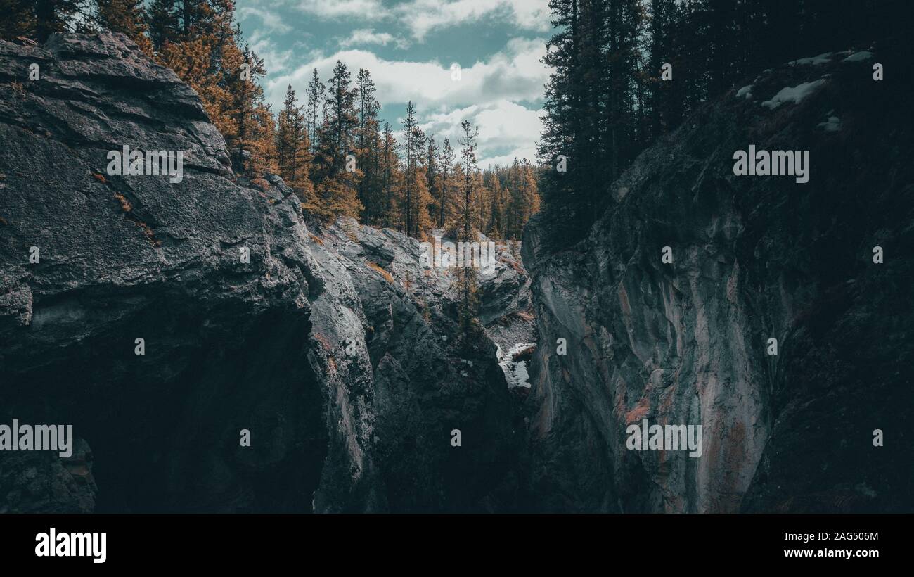 Beautiful mountain cliffs covered with trees under the clouds Stock ...