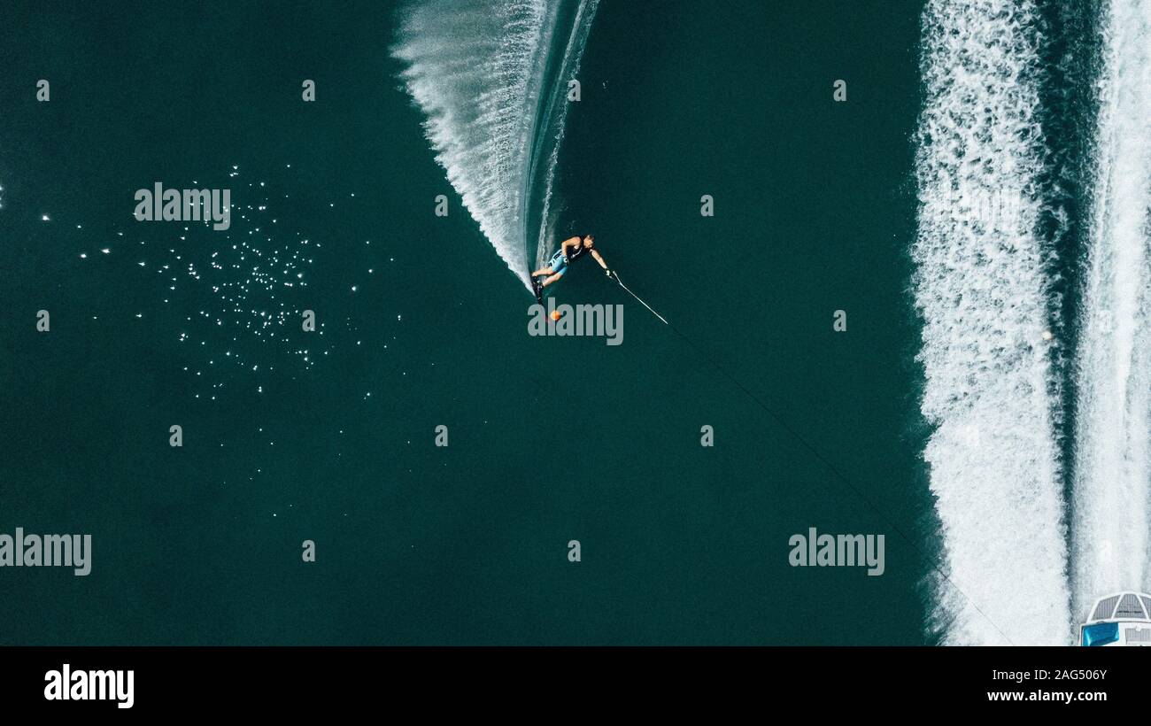 High angle shot of a person surfing on the waves of the ocean Stock ...